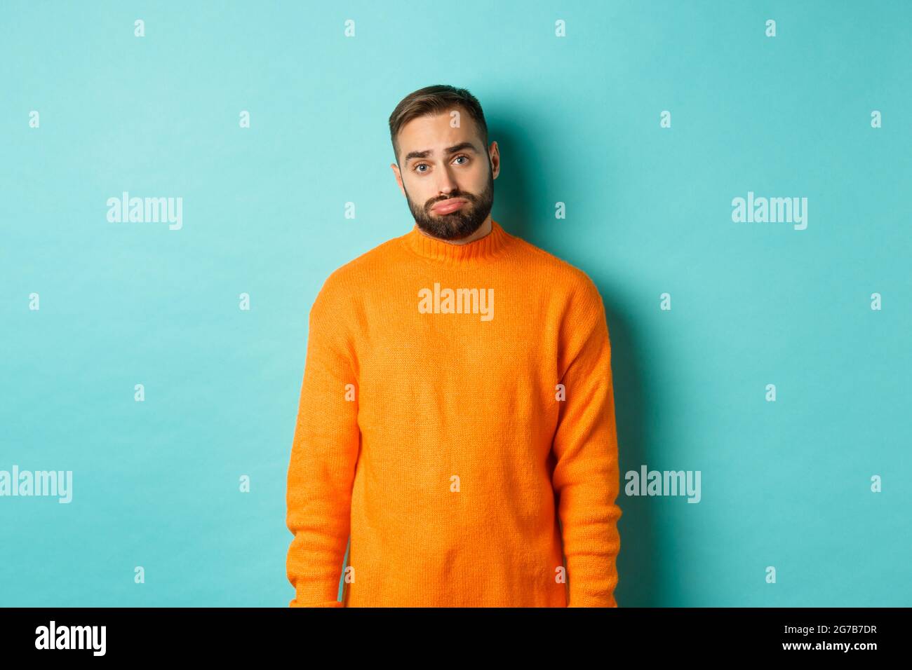 Sad man looking at camera, sulking and feeling distressed, standing ...