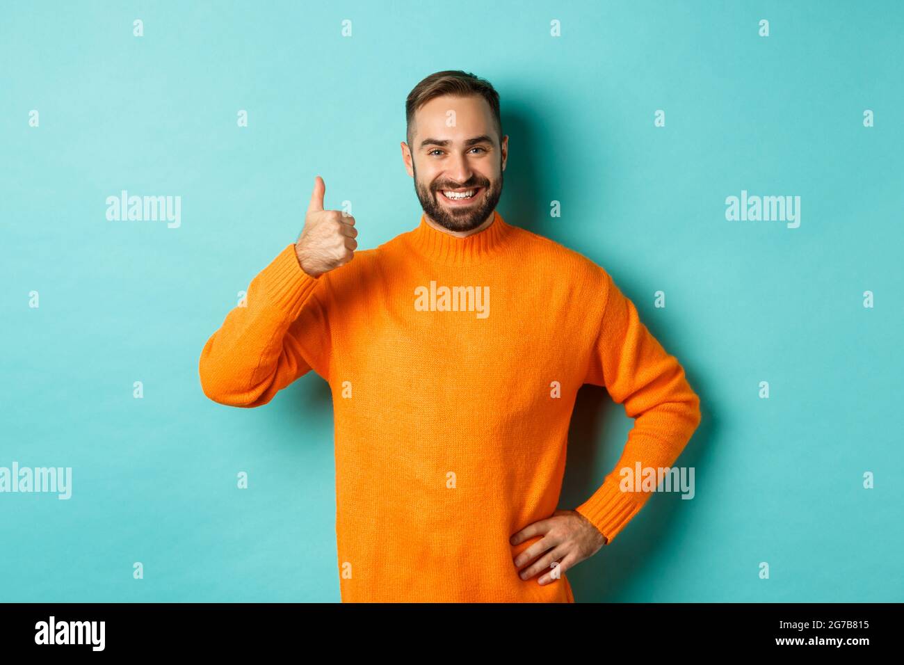 Well done. Handsome bearded man showing thumb up, praising good work ...