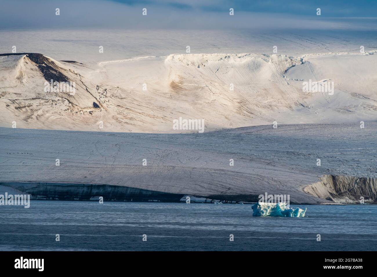 Iceberg floating before the flat table mountains covered with ice ...
