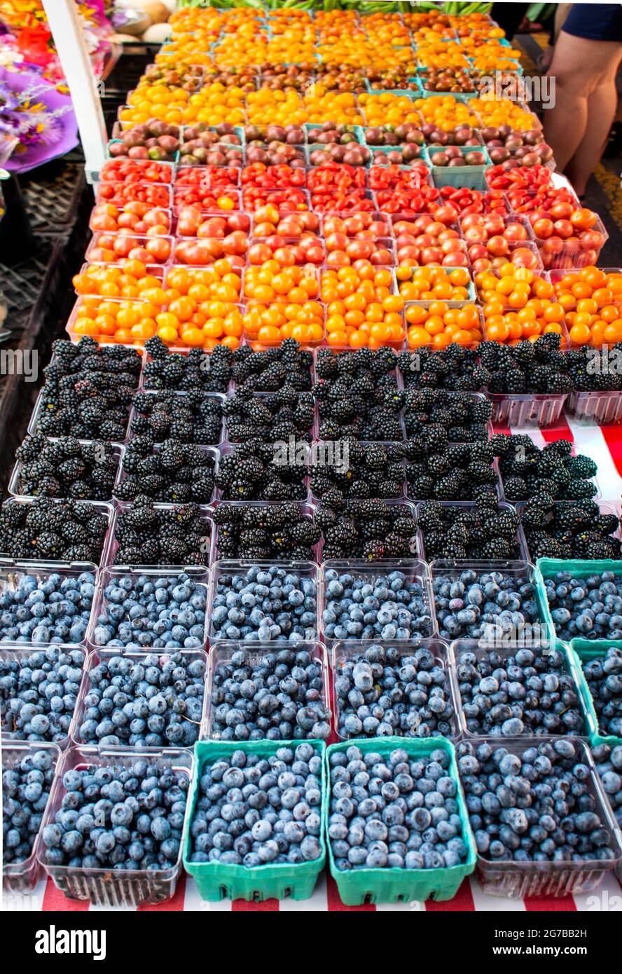 A table filled will different types of fruit on display for sale, at a ...