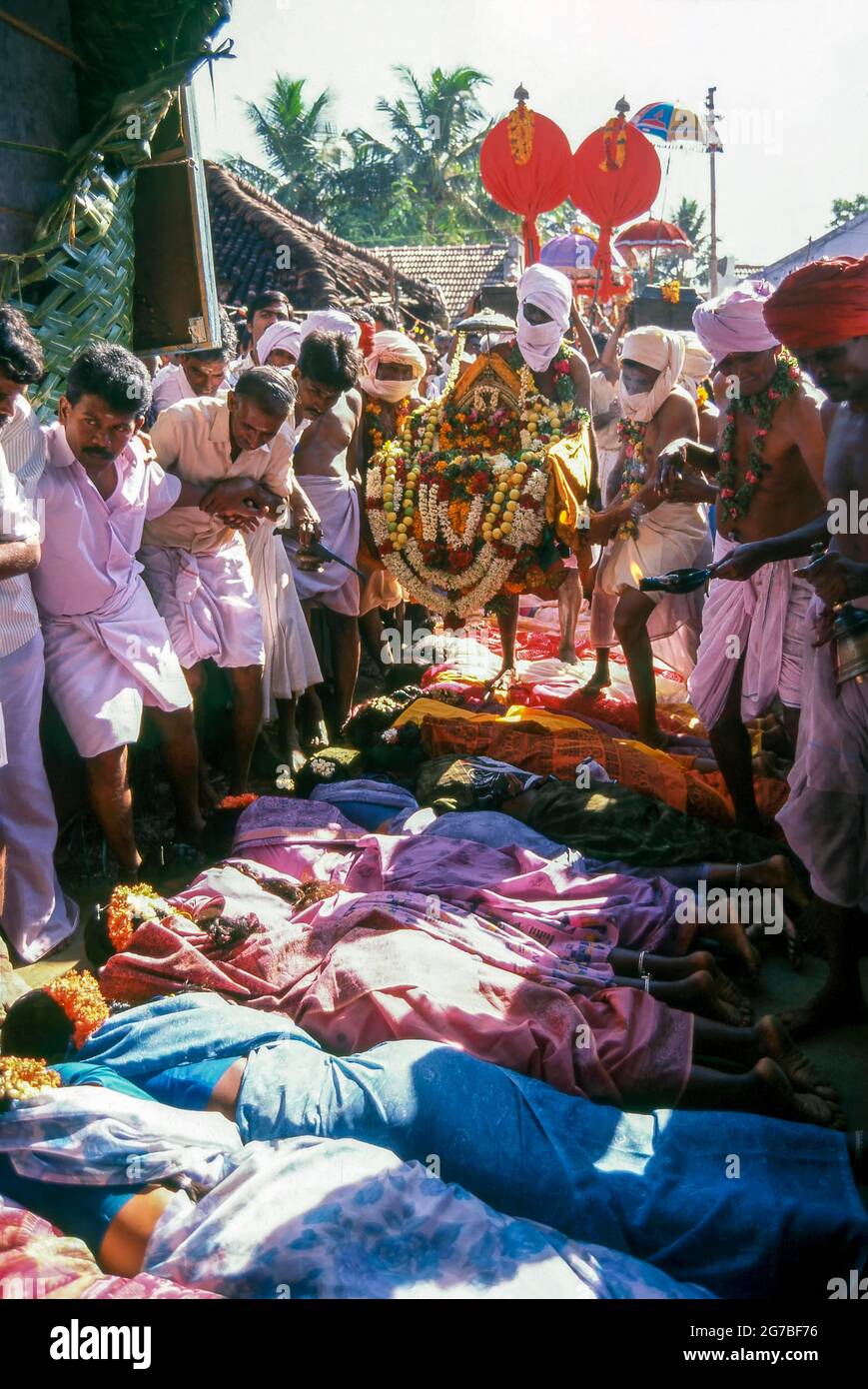 Poojari or priest walking on women in Mahasivaratri festival at ...
