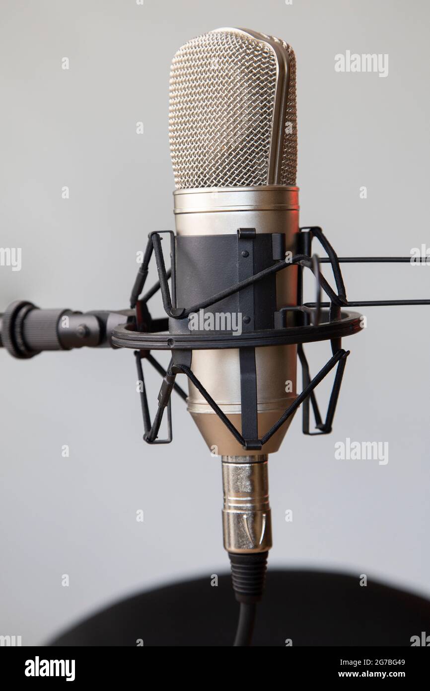 closeup to a professional microphone with a stand and cable, musical ...