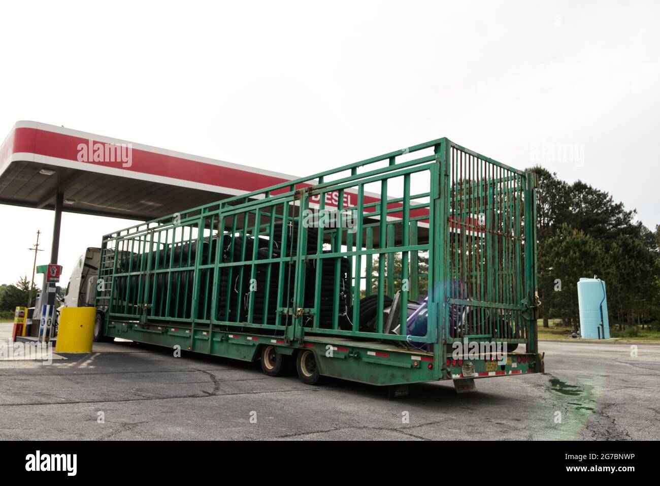 Augusta, Ga USA - 04 29 21: Distant back green cage trailer on a semi ...