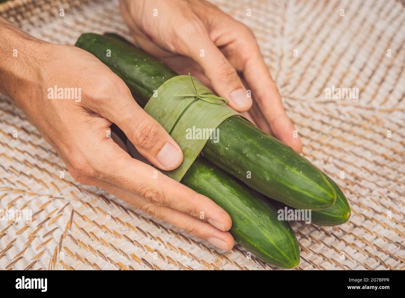 Eco-friendly product packaging concept. Cucumber wrapped in a banana ...