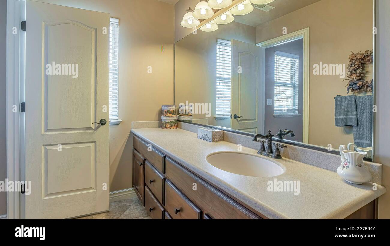 Pano Vanity unit with single oval sink on white countertop over brown ...