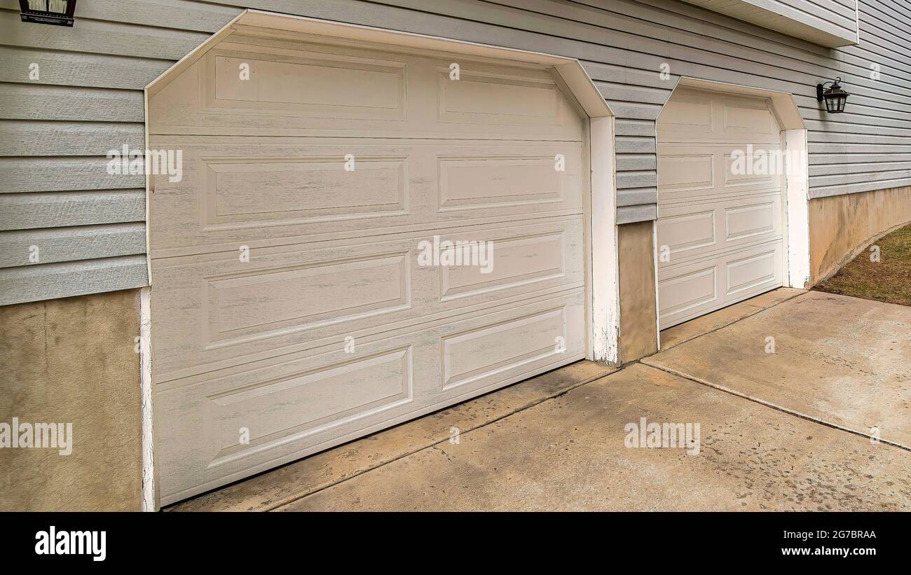 Pano Back view of a storey house with attached two car garage and gray ...
