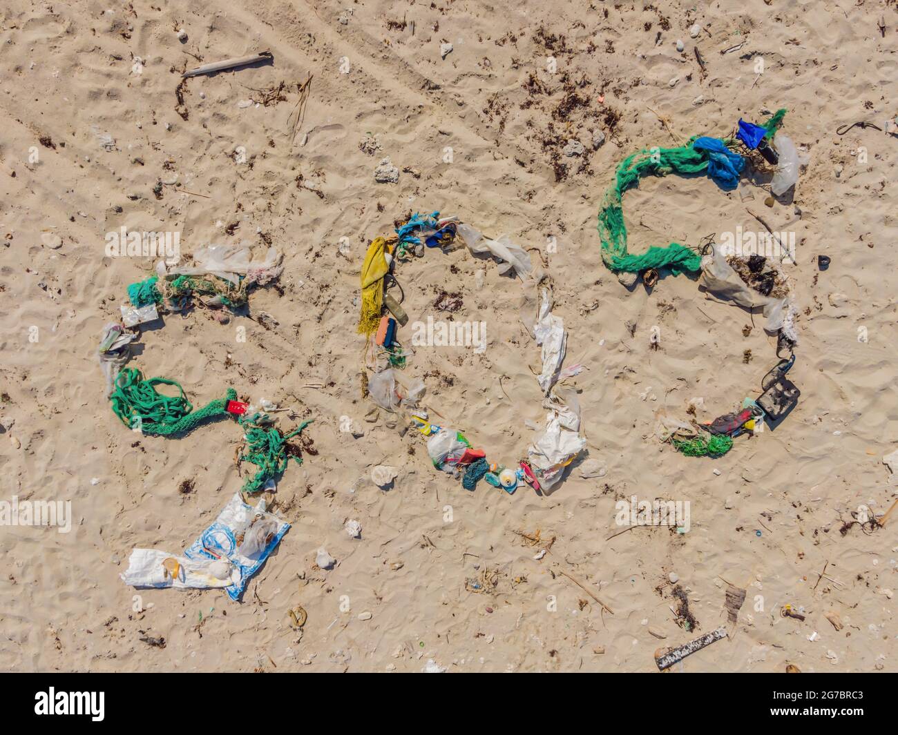 Environmental problem. Ecology concept. Plastic on the beach with sos ...