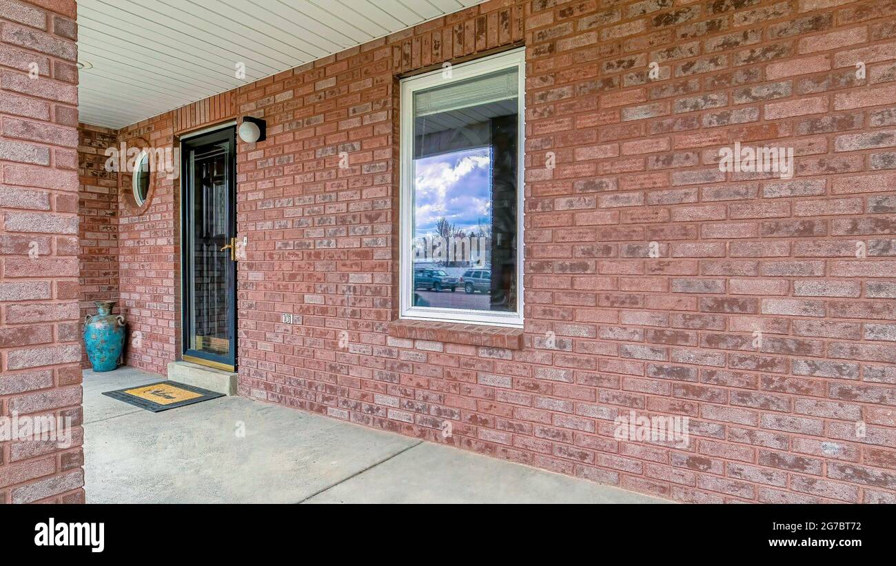 Pano Spacious and open wrap around concrete porch of house with brick ...
