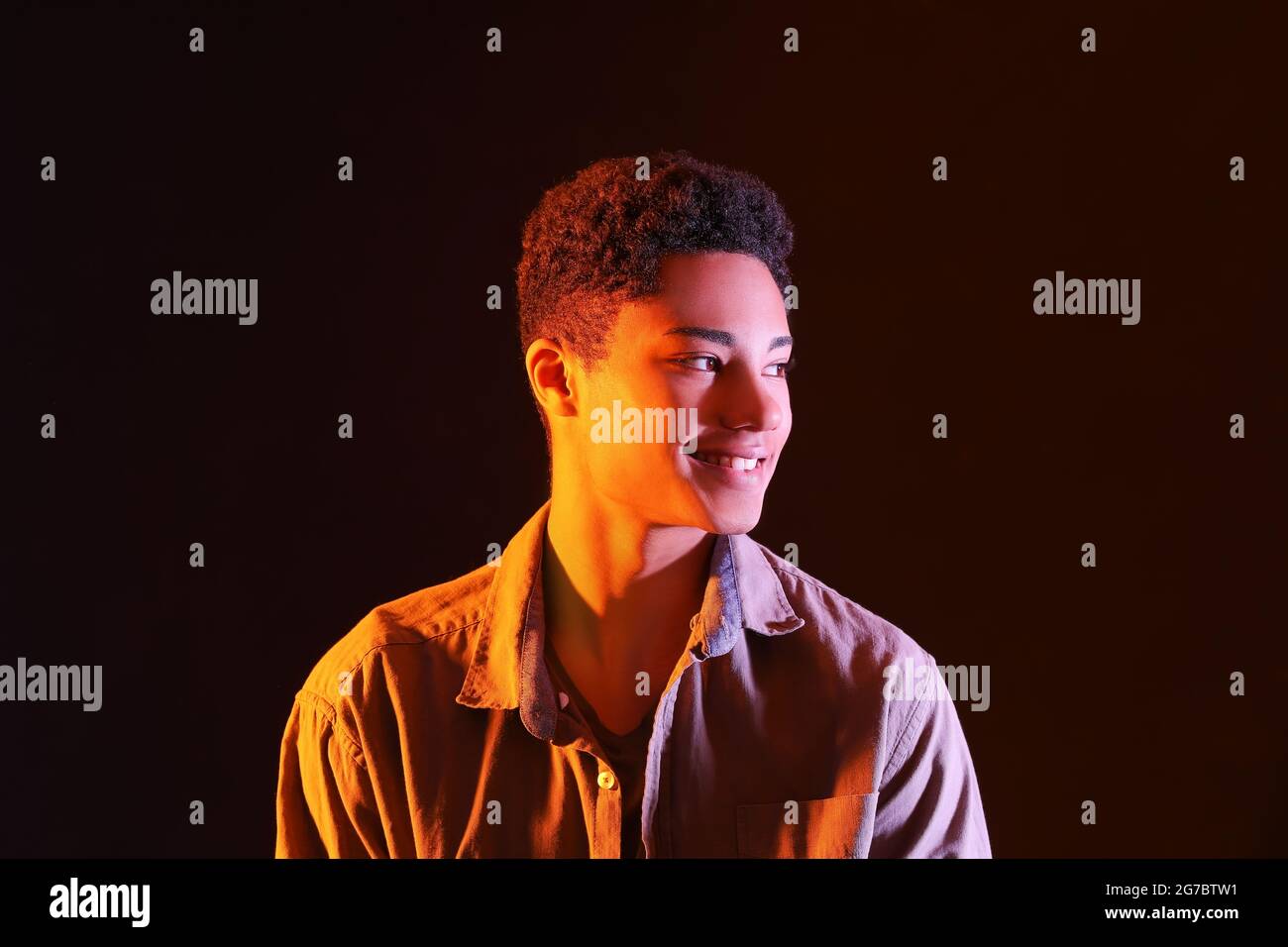 Portrait of African-American teenage boy on dark background Stock Photo ...
