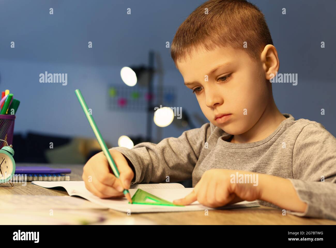 Little boy doing homework at home late in evening Stock Photo - Alamy
