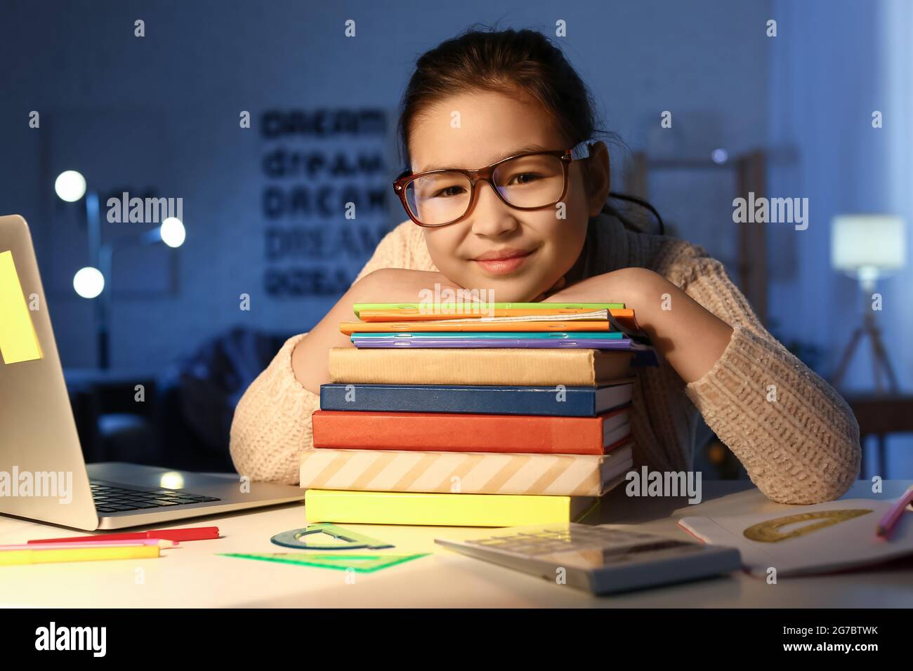 Little girl doing homework at home late in evening Stock Photo - Alamy