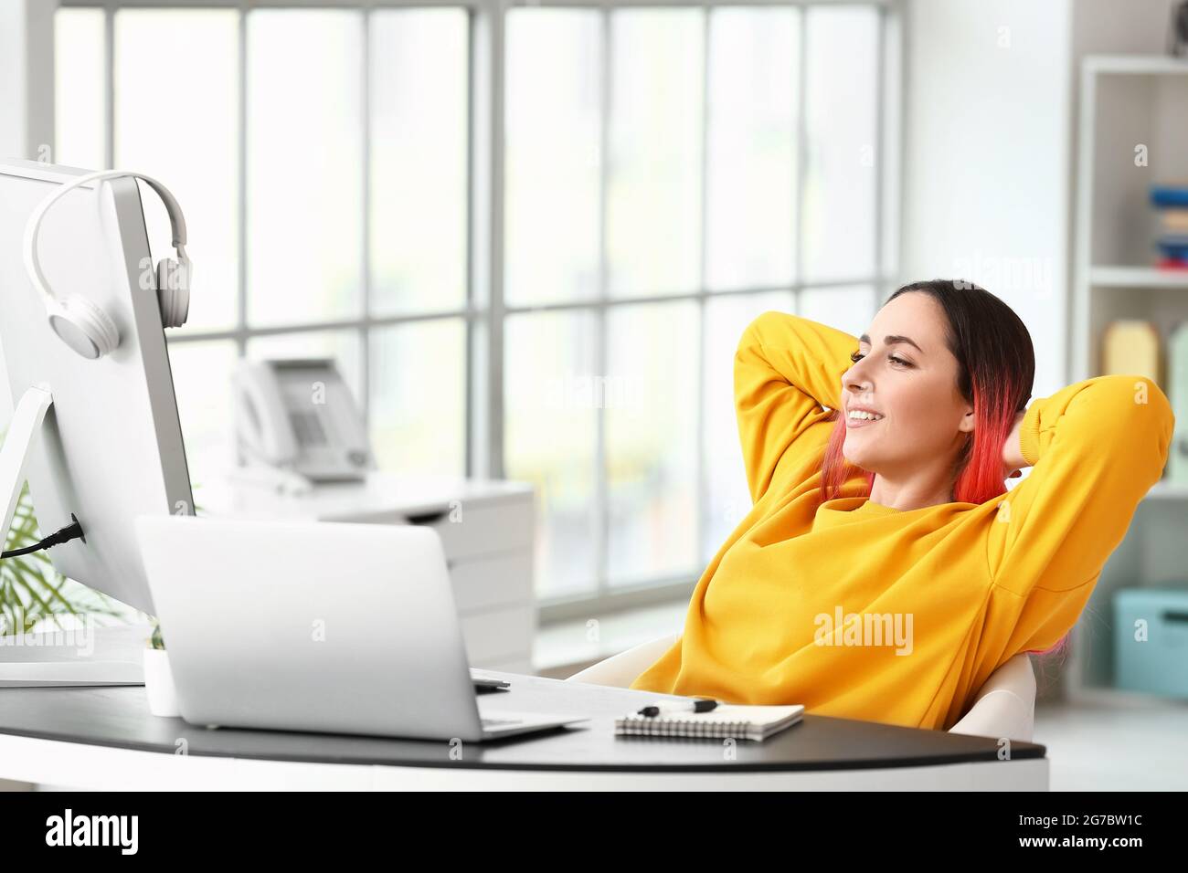 Female programmer relaxing in office Stock Photo - Alamy