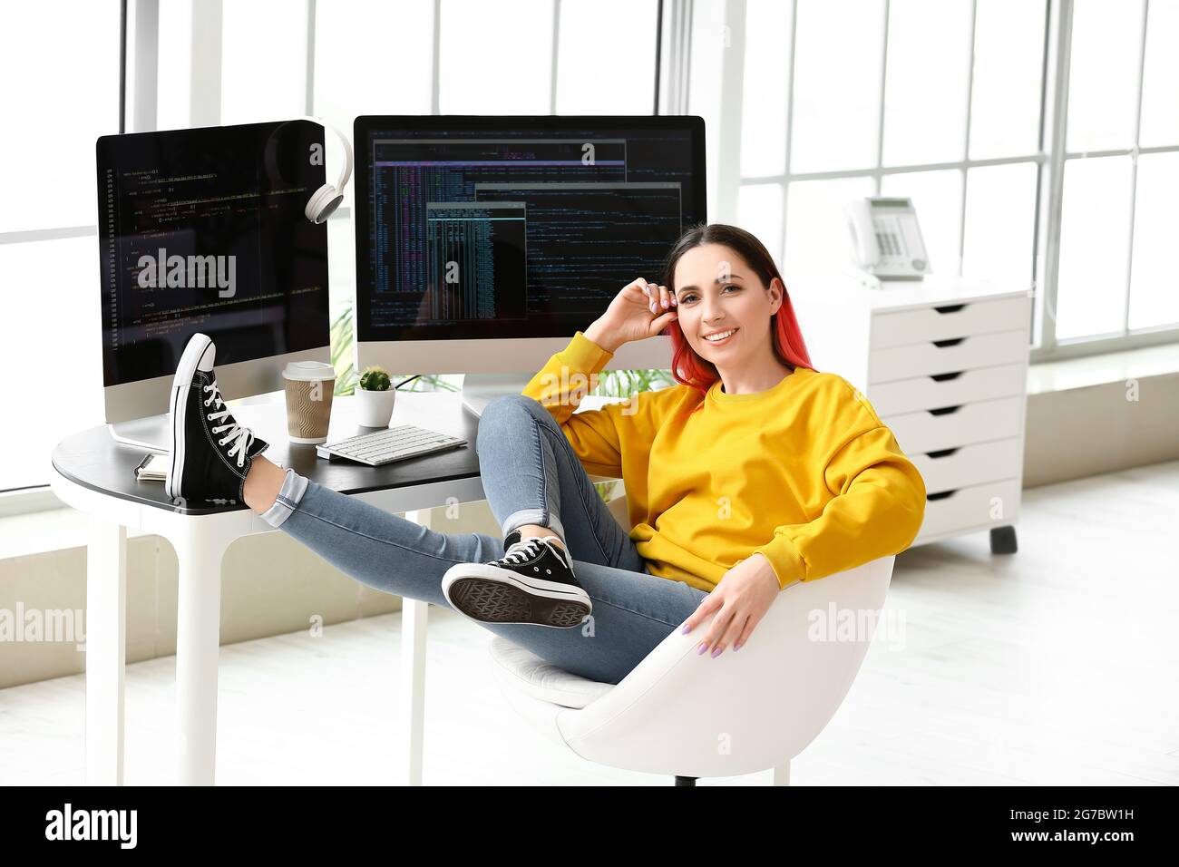 Female programmer working in office Stock Photo - Alamy