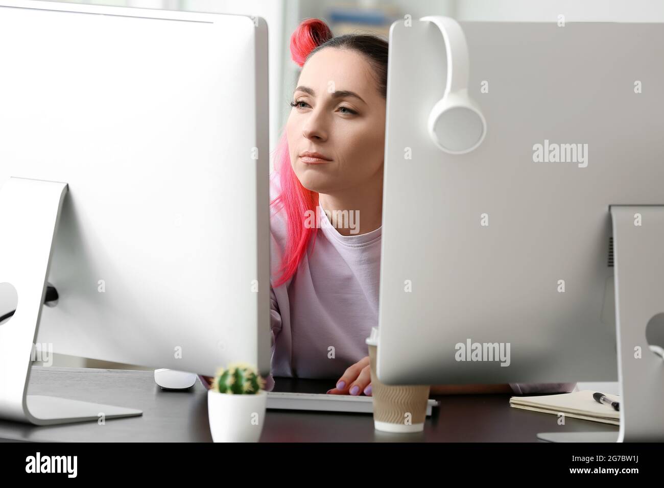Female programmer working with computer in office Stock Photo - Alamy