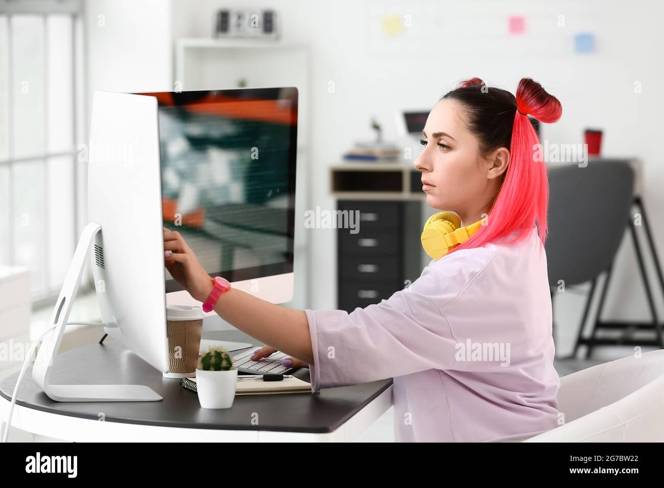 Female programmer working with computer in office Stock Photo - Alamy
