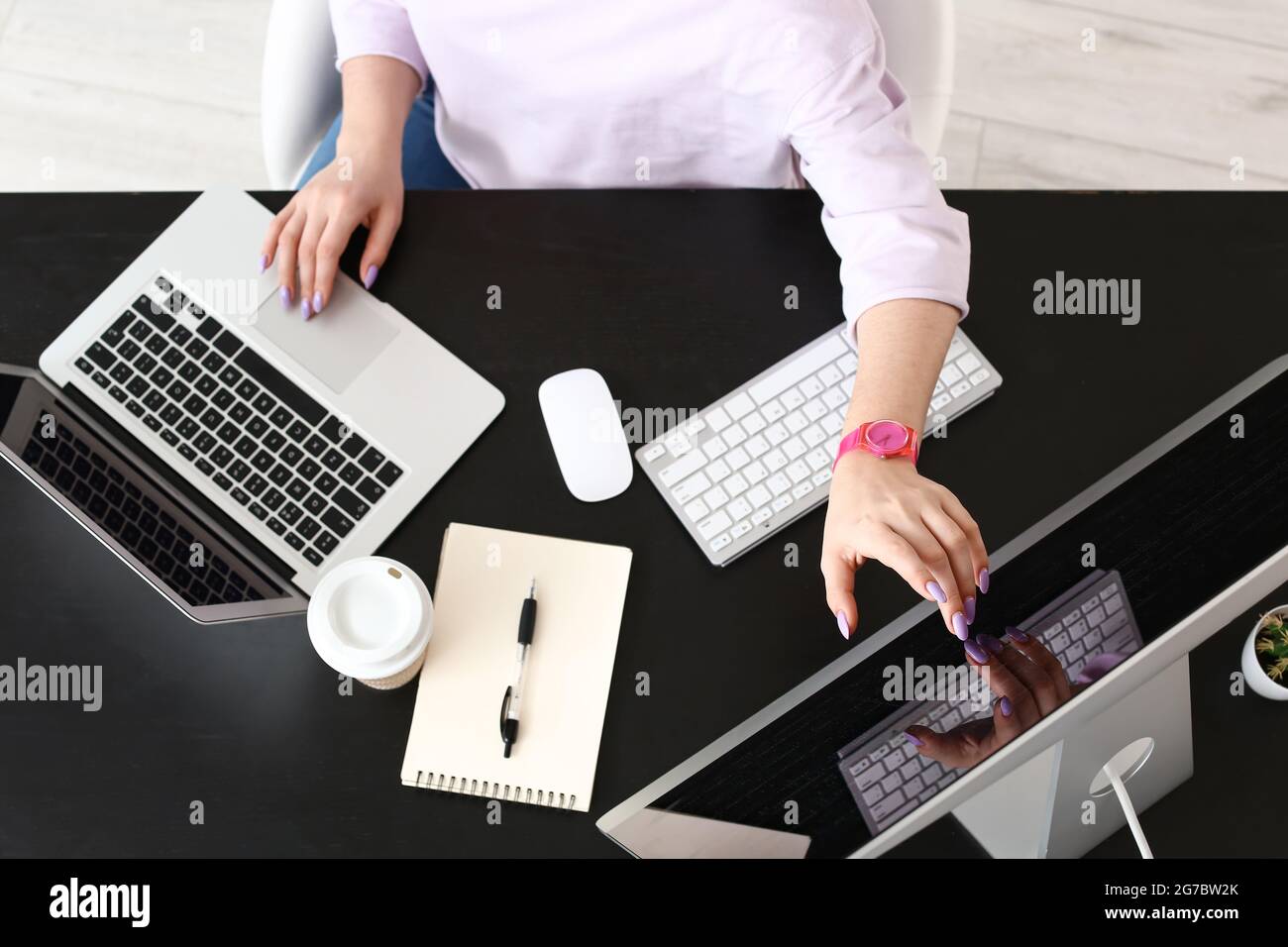 Female programmer working with laptop and computer in office Stock ...
