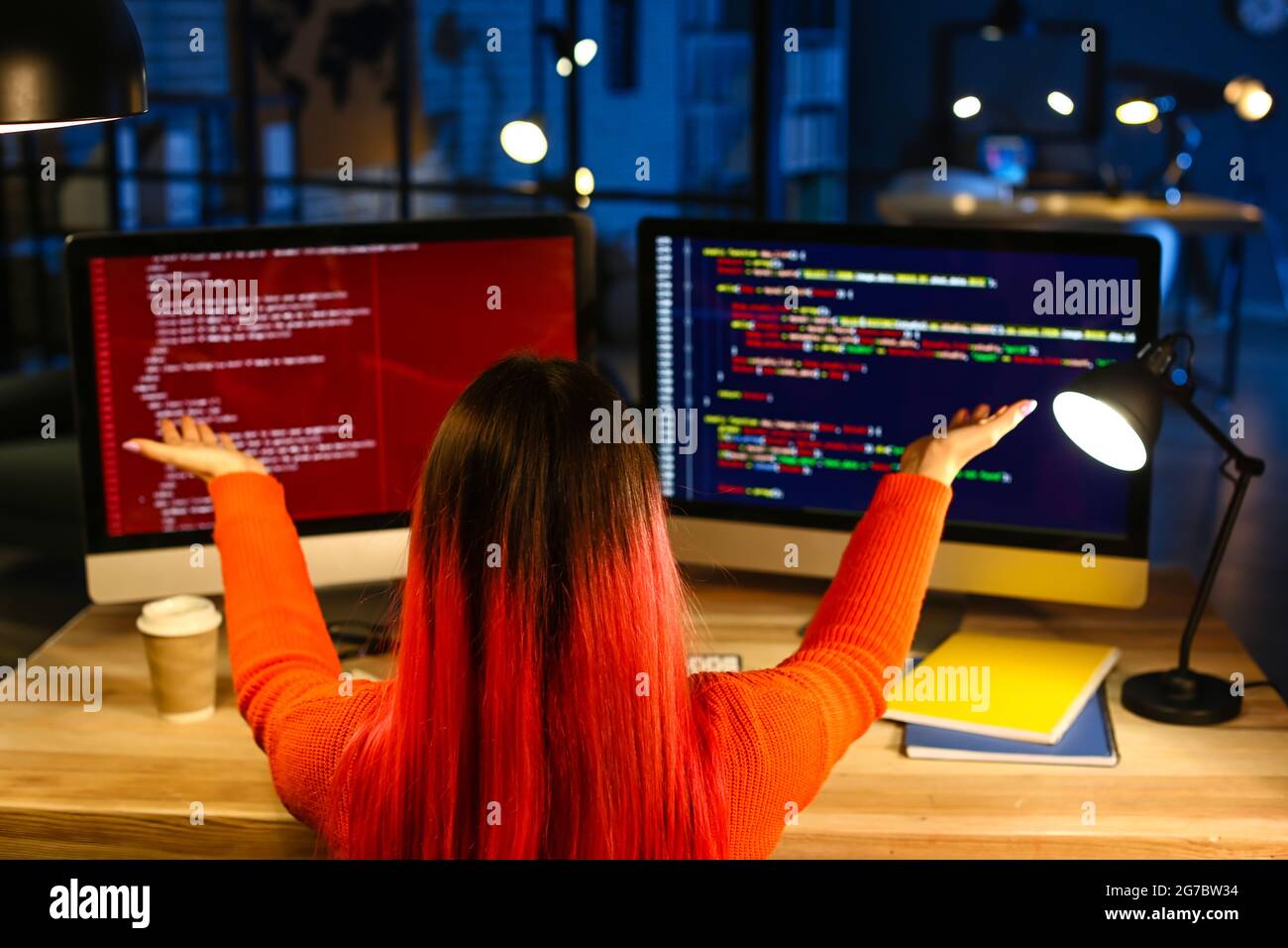 Female programmer working with computer in office at night Stock Photo ...