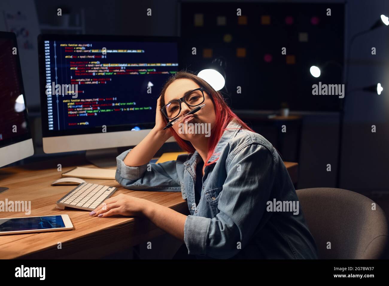 Female programmer working in office at night Stock Photo - Alamy