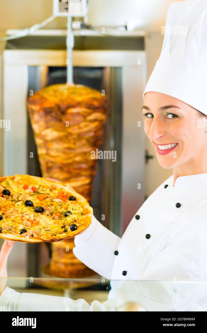 Doner kebab - friendly female vendor in a Turkish fast food eatery ...