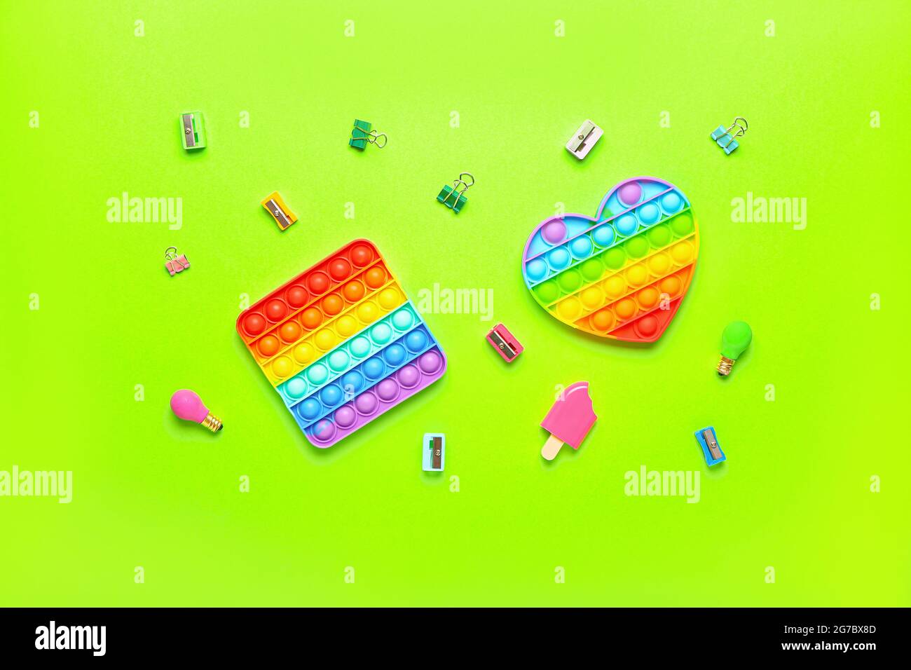 Pop it fidget toys and stationery on color background Stock Photo - Alamy