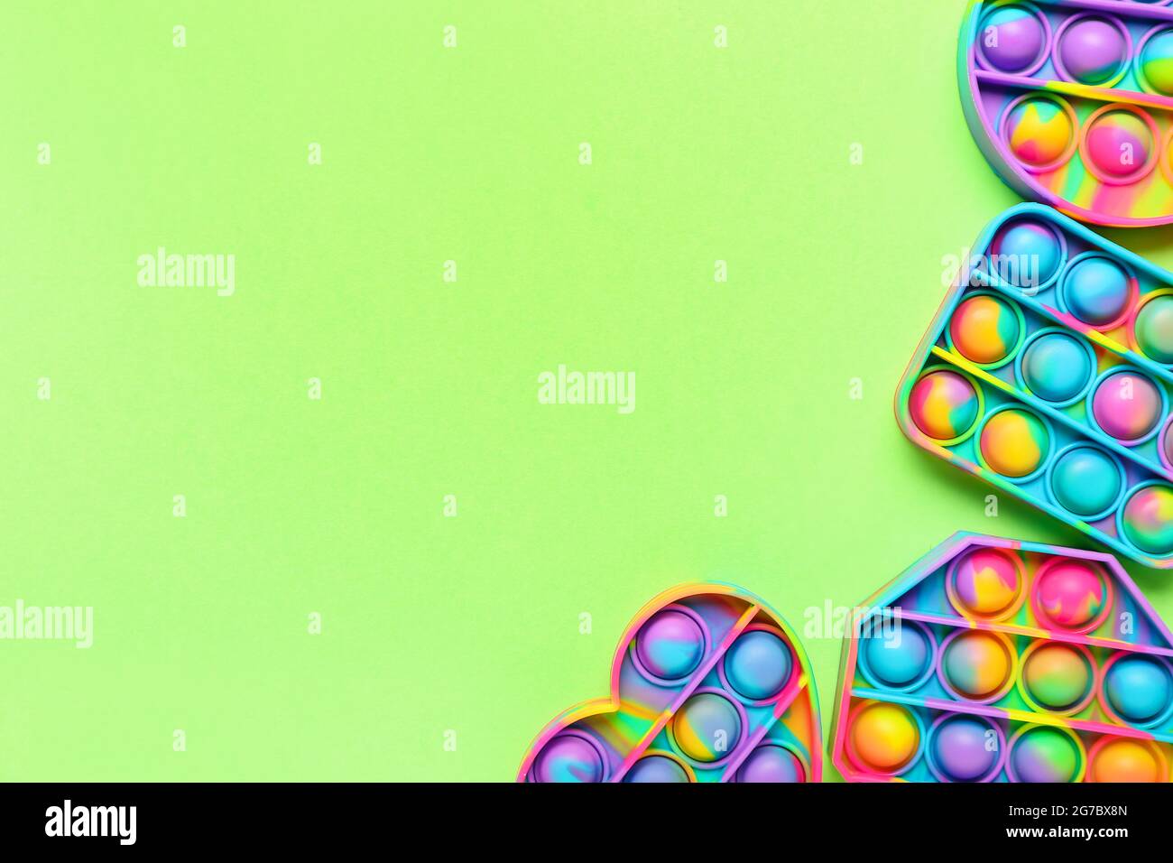 Pop it fidget toys on color background Stock Photo - Alamy