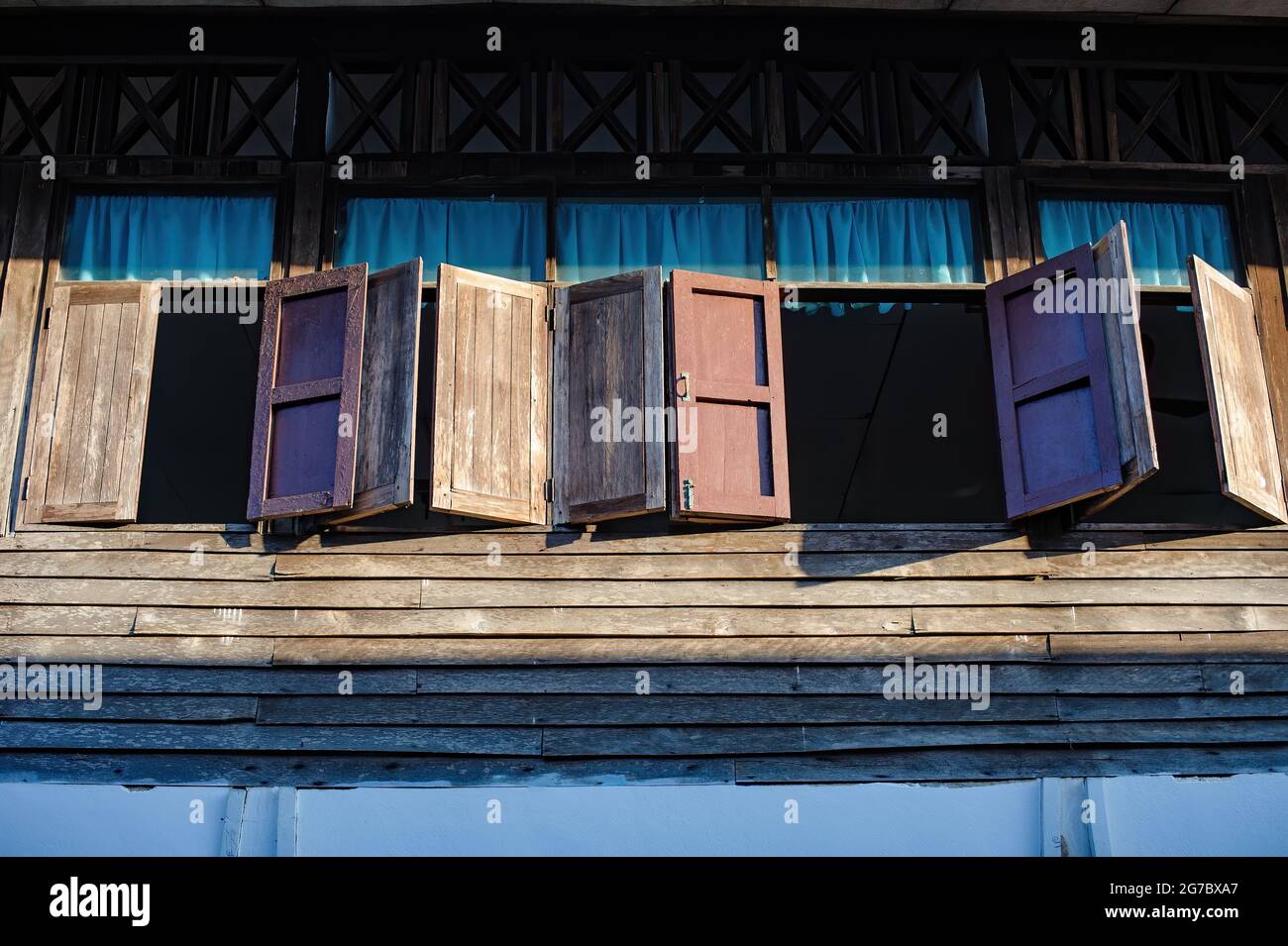 many opened old wooden windows of old style school building somewhere ...
