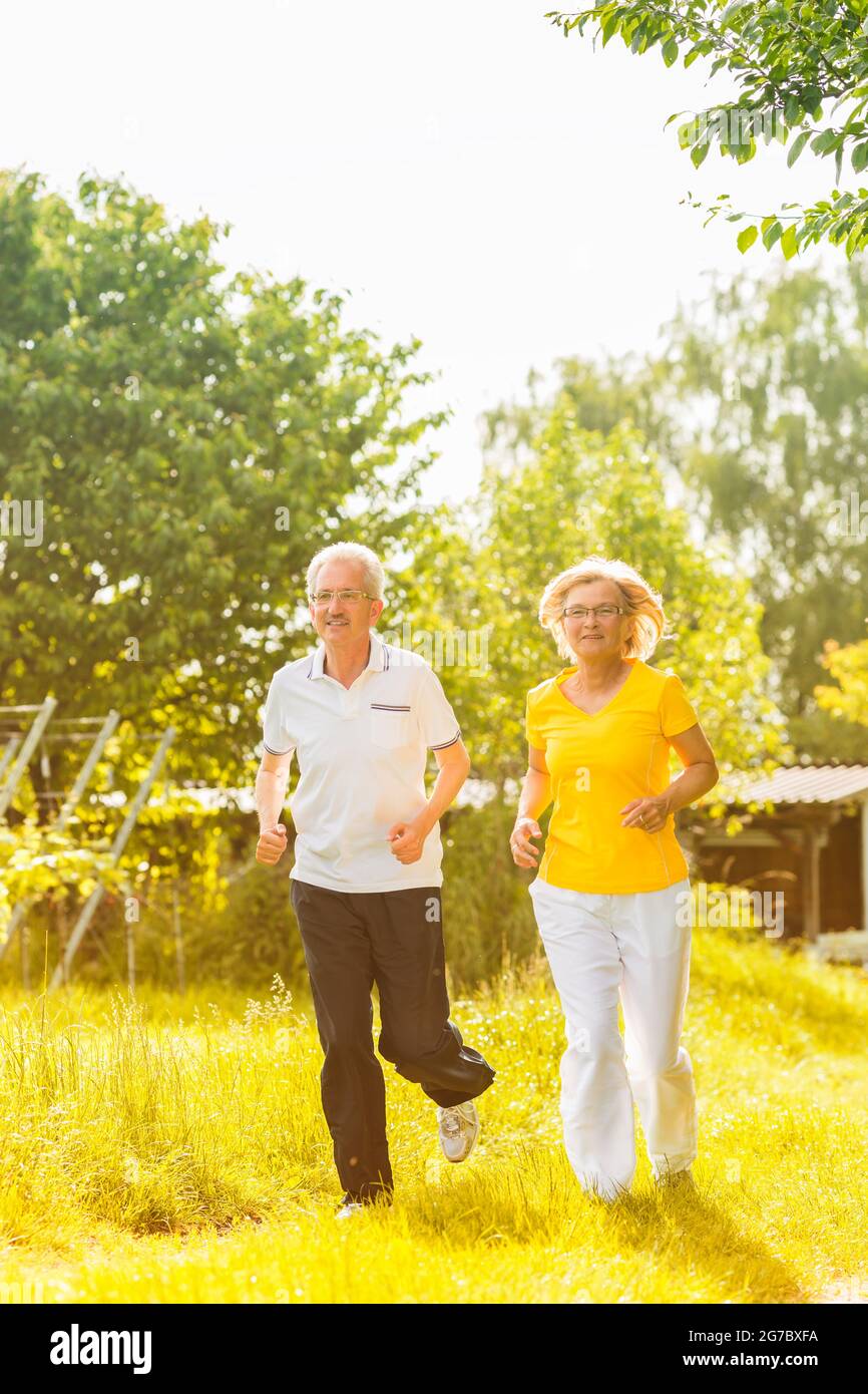 Senior man jogging on grass hi-res stock photography and images - Alamy