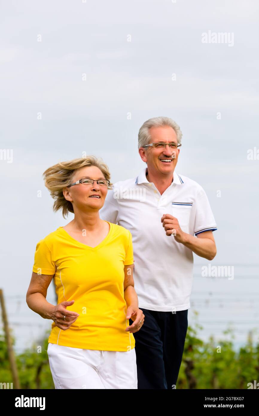 Seniors jogging in the nature doing sport Stock Photo - Alamy