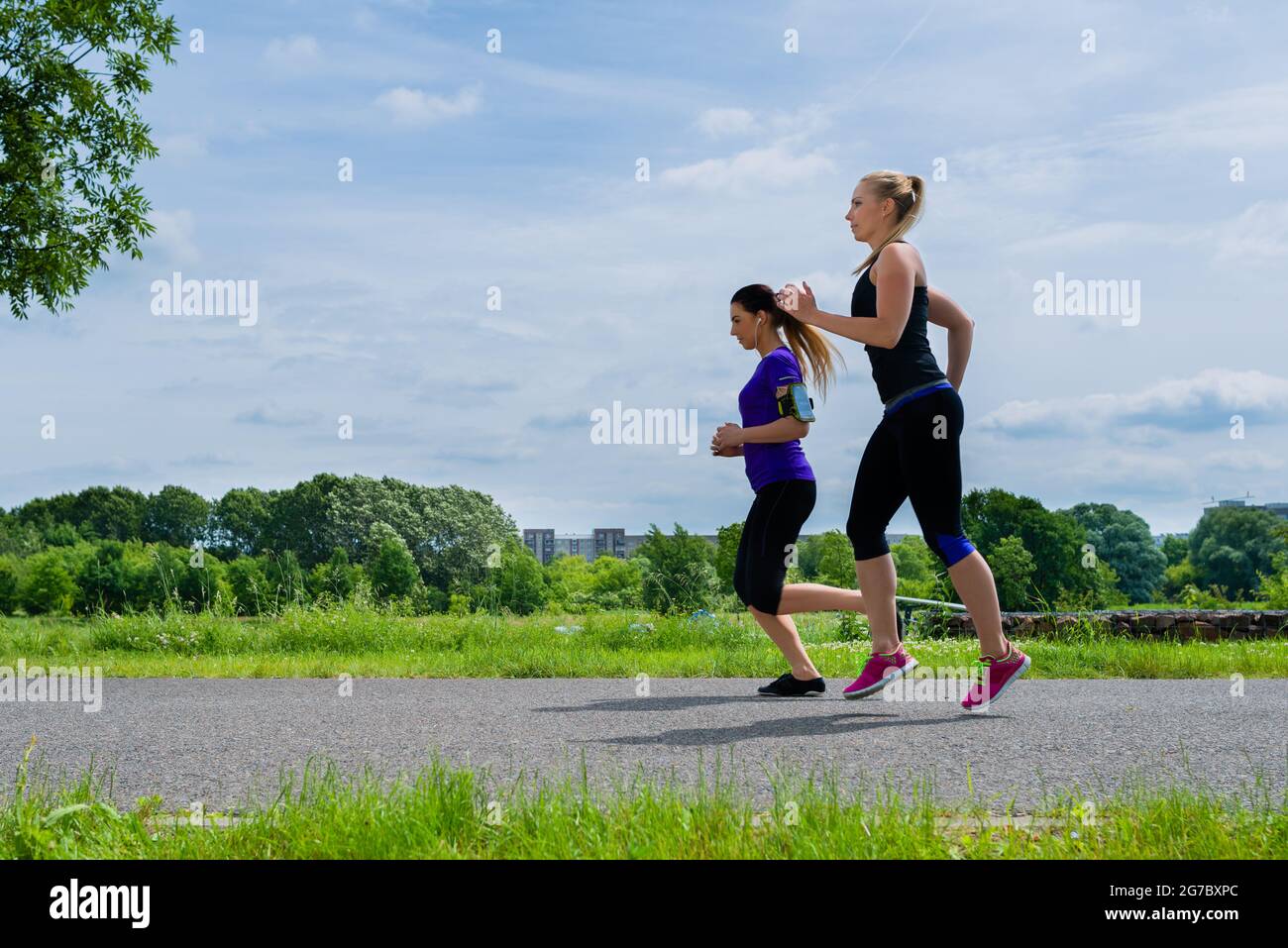 Women running together park hi-res stock photography and images - Alamy