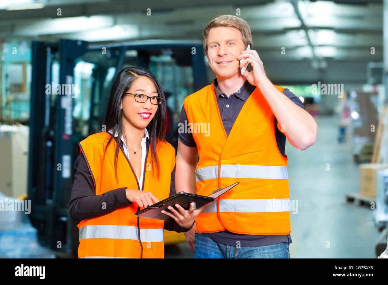 Logistics Teamwork - Worker or warehouseman and his female coworker ...
