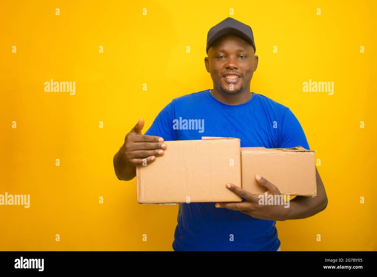 An African delivery personnel or dispatch man wearing a blue shirt ...