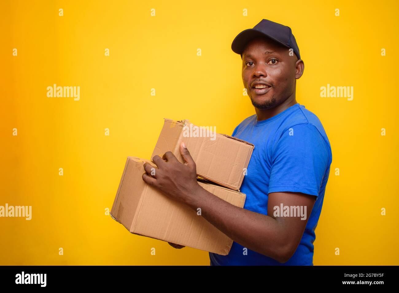 An African delivery personnel or dispatch man wearing a blue shirt ...