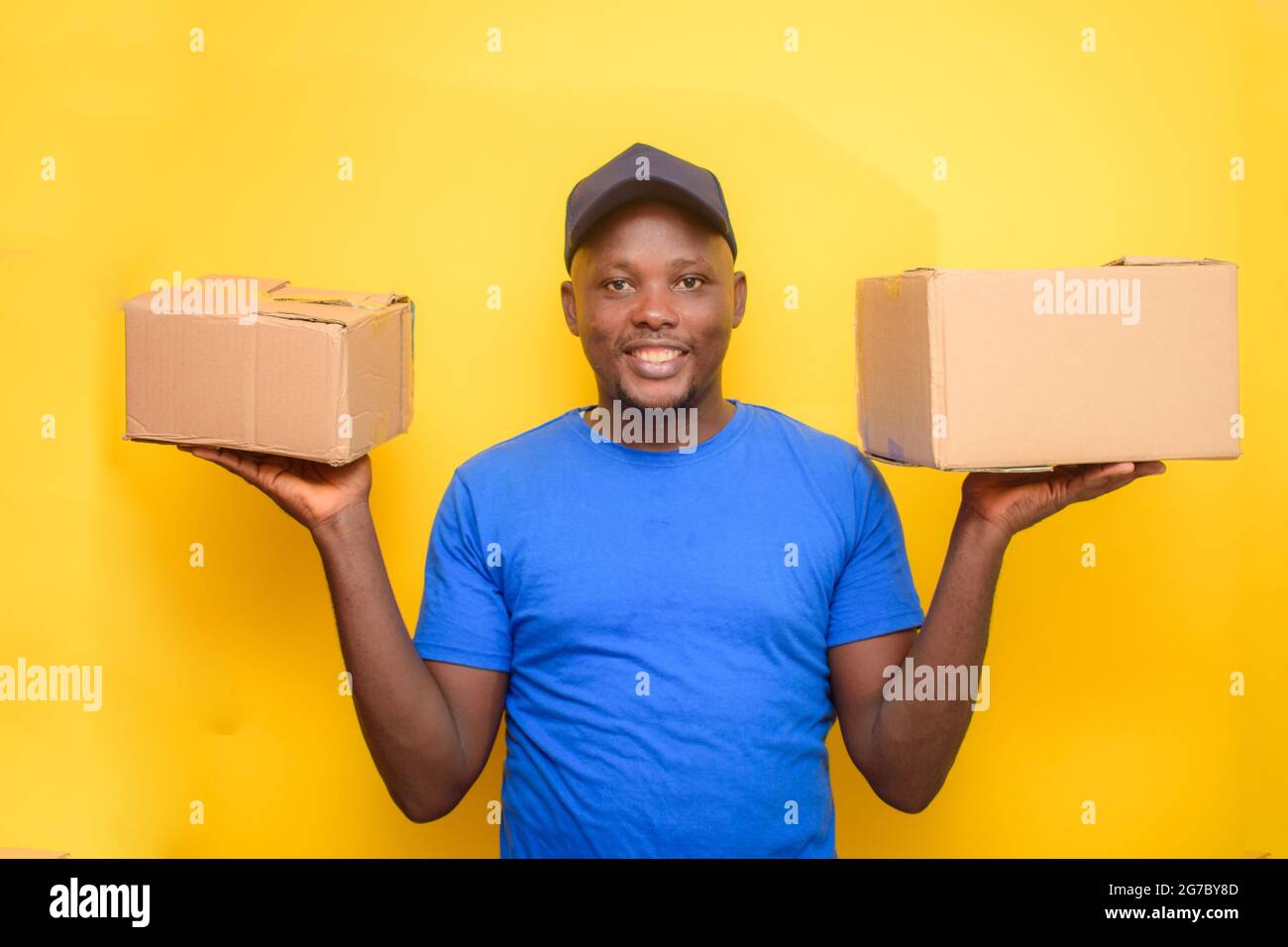An African delivery personnel or dispatch man wearing a blue shirt ...