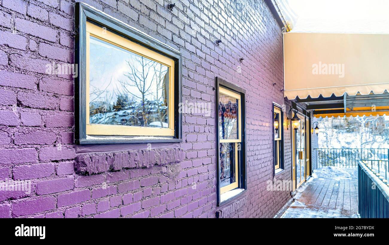 Pano Building exterior with awning over the snowy wooden deck at the ...