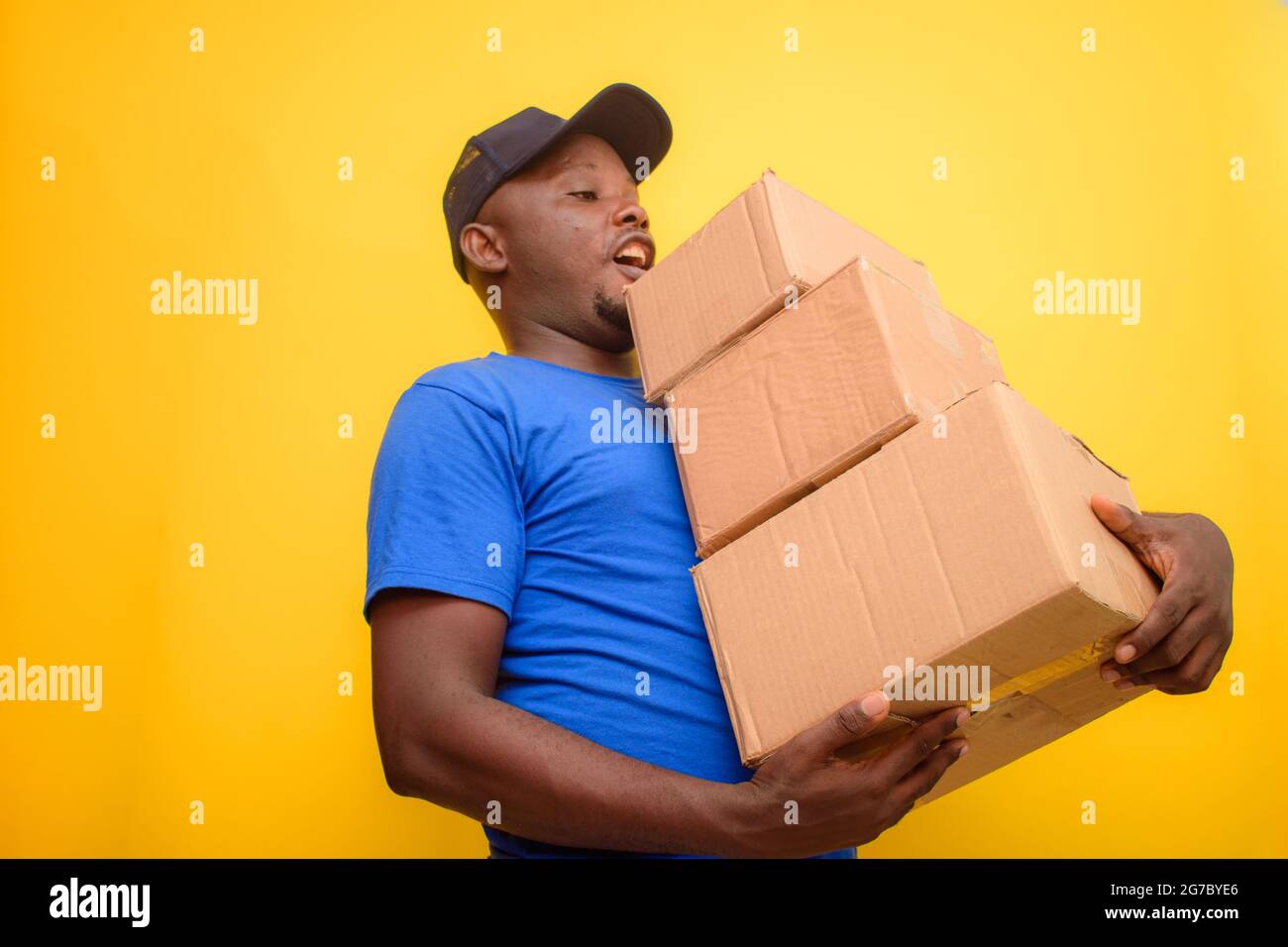 An African delivery personnel or dispatch man wearing a blue shirt ...