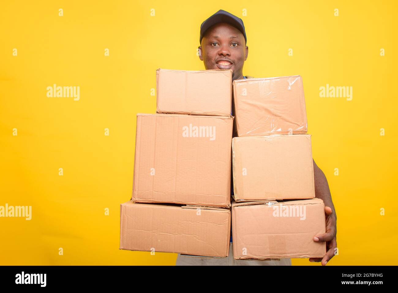 An African delivery personnel or dispatch man wearing a blue shirt ...