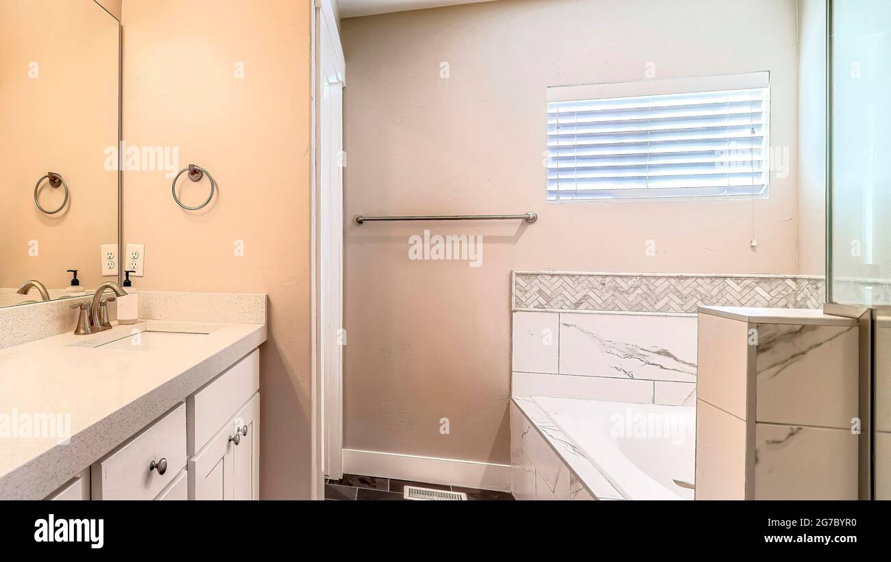 Pano Interior of clean residential bathroom with bathtub and double ...
