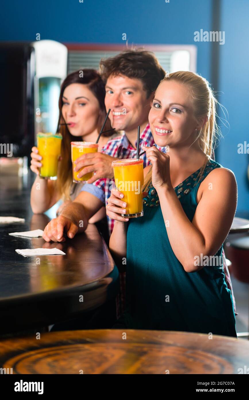 Young people in club or bar drinking cocktails and having fun Stock ...