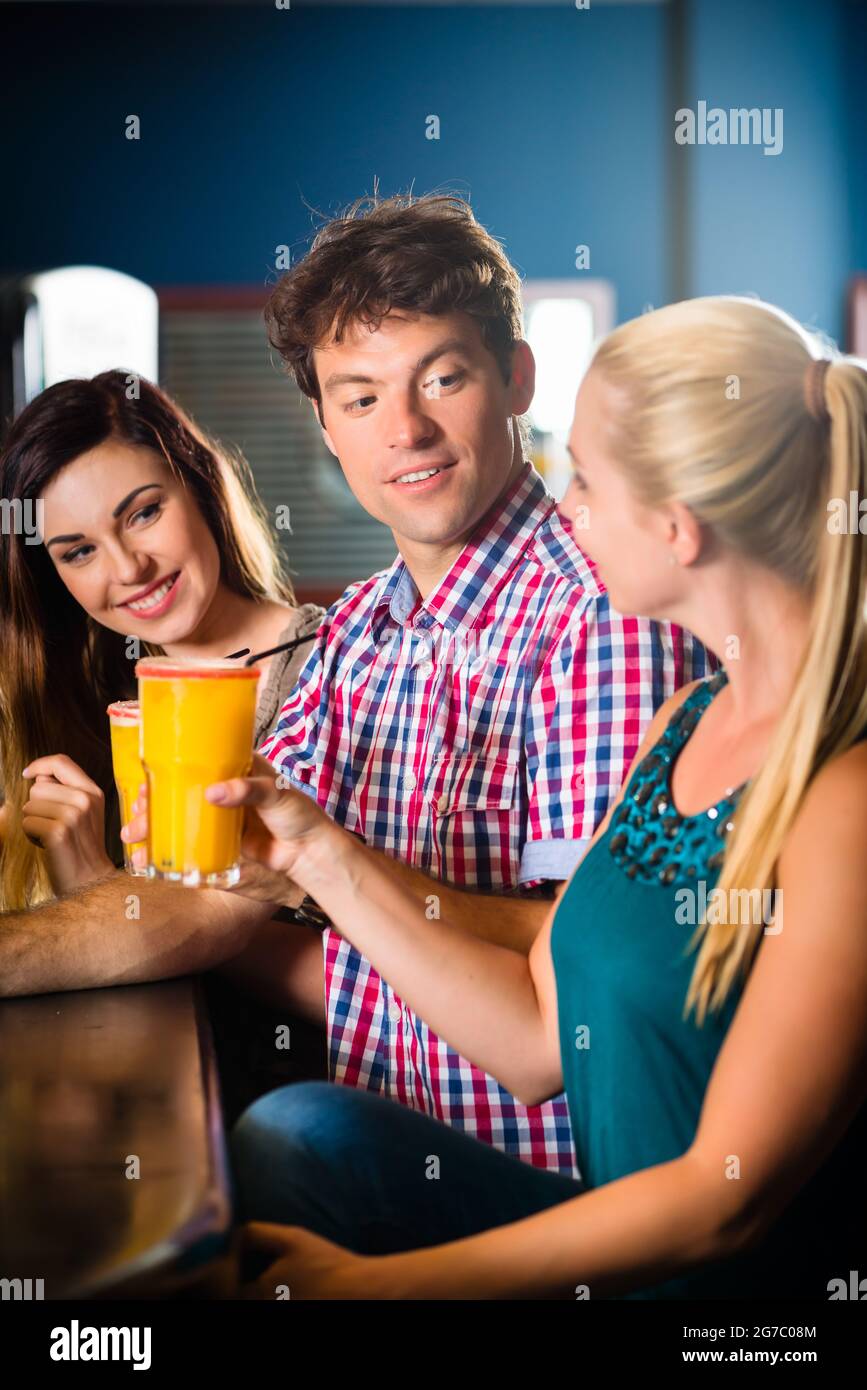 Young people in club or bar drinking cocktails and having fun Stock ...