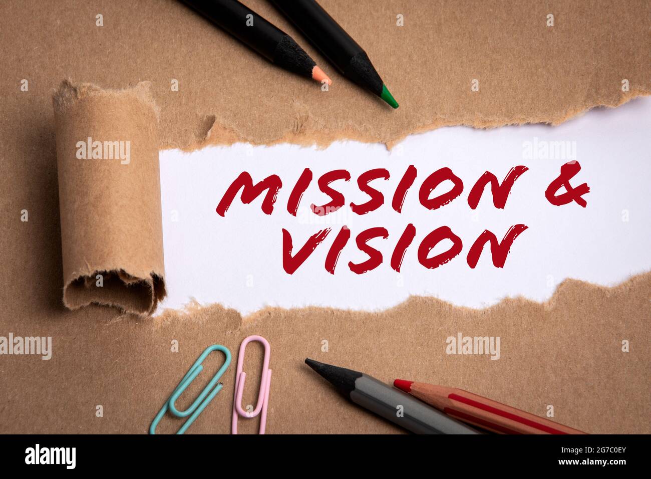 Mission and vision concept. Cardboard paper and pencils on a white ...