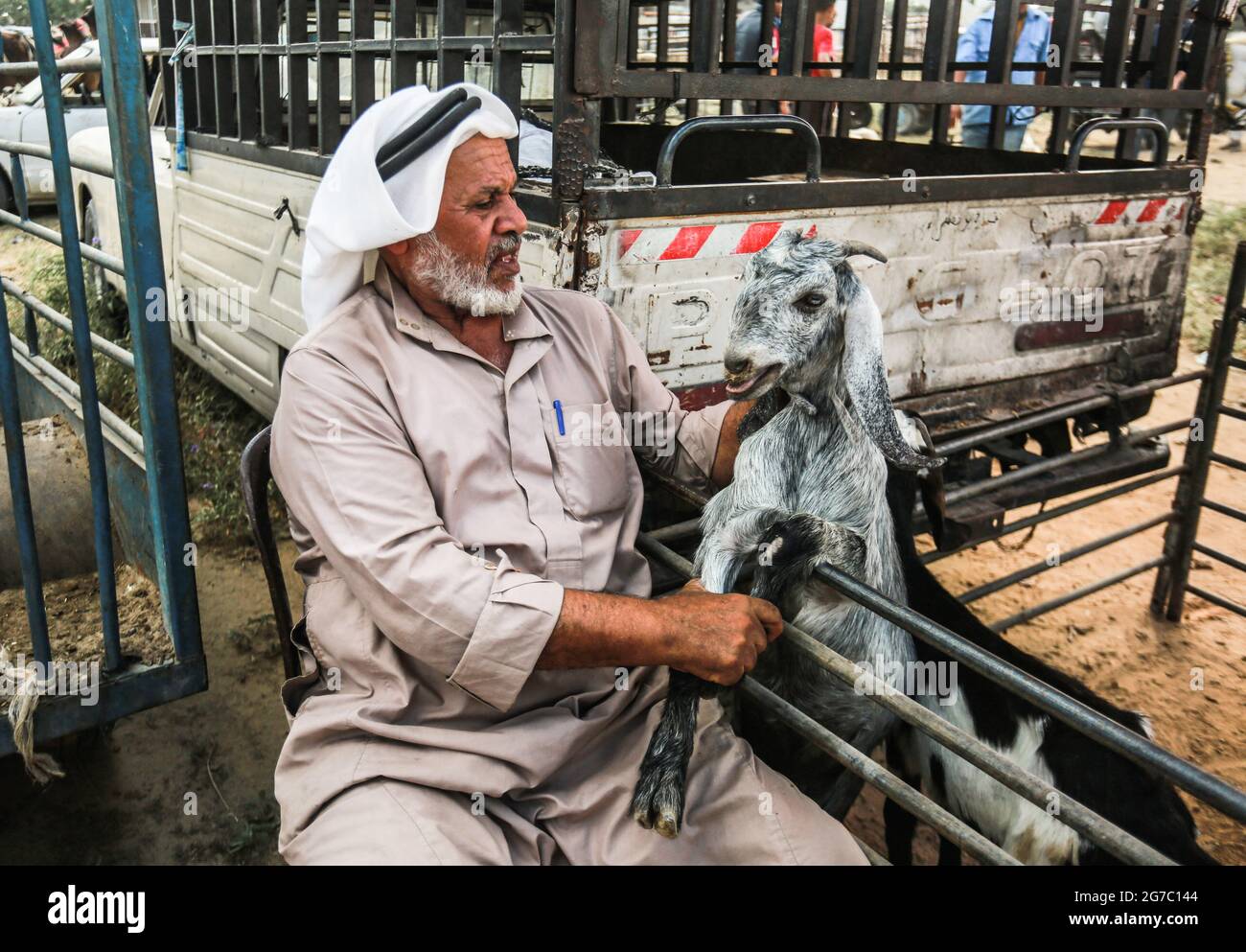 Gaza, Palestine. 06th July, 2021. A Palestinian man holds a sheep at a ...