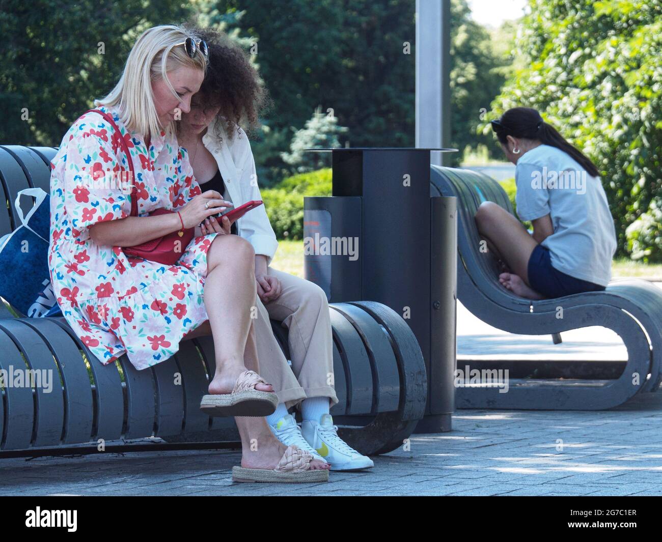 Moscow, Russia. 6th July, 2021. Citizens sitting on park benches seen ...