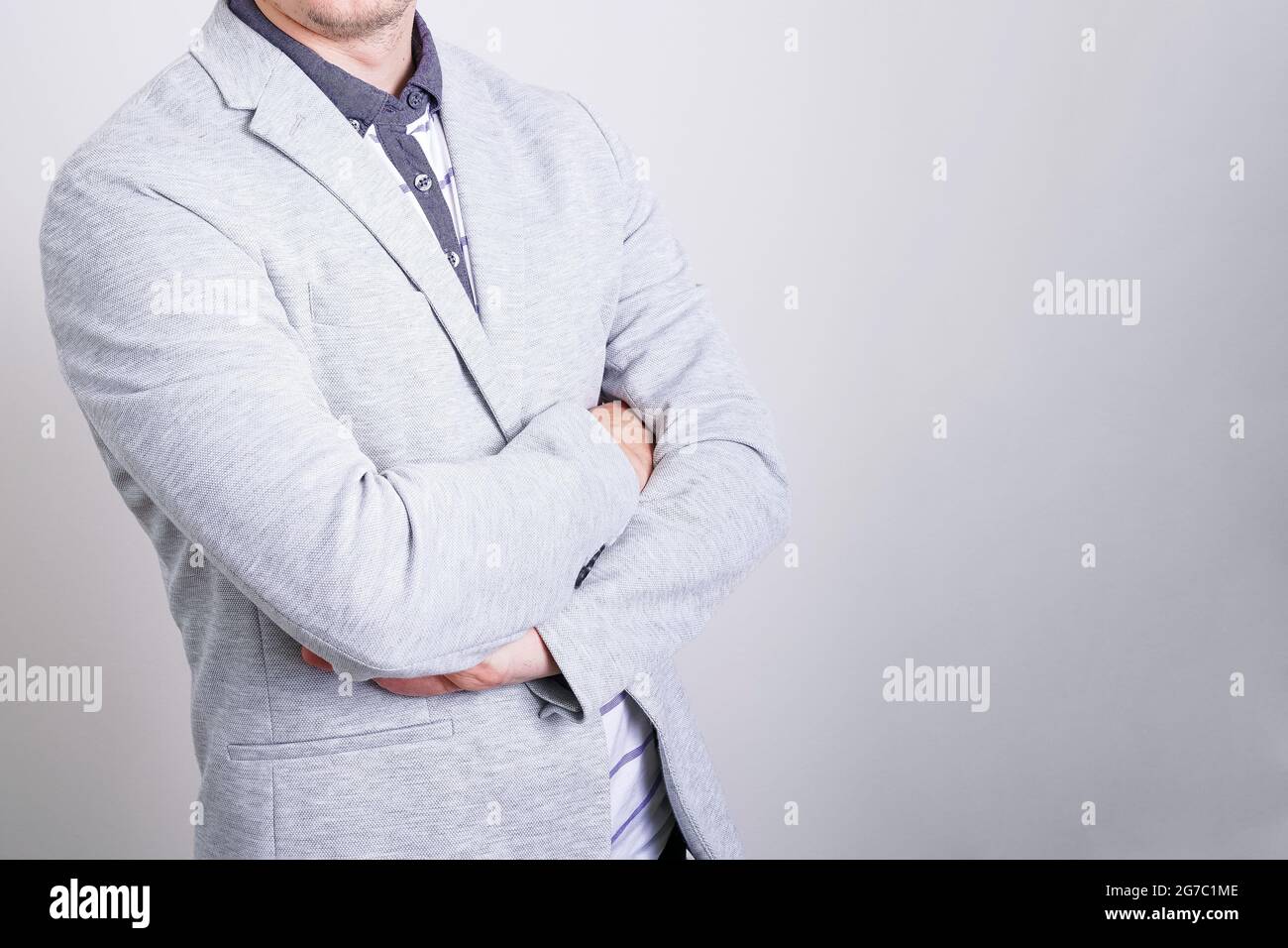 A business man on a light background without a face with folded hands ...