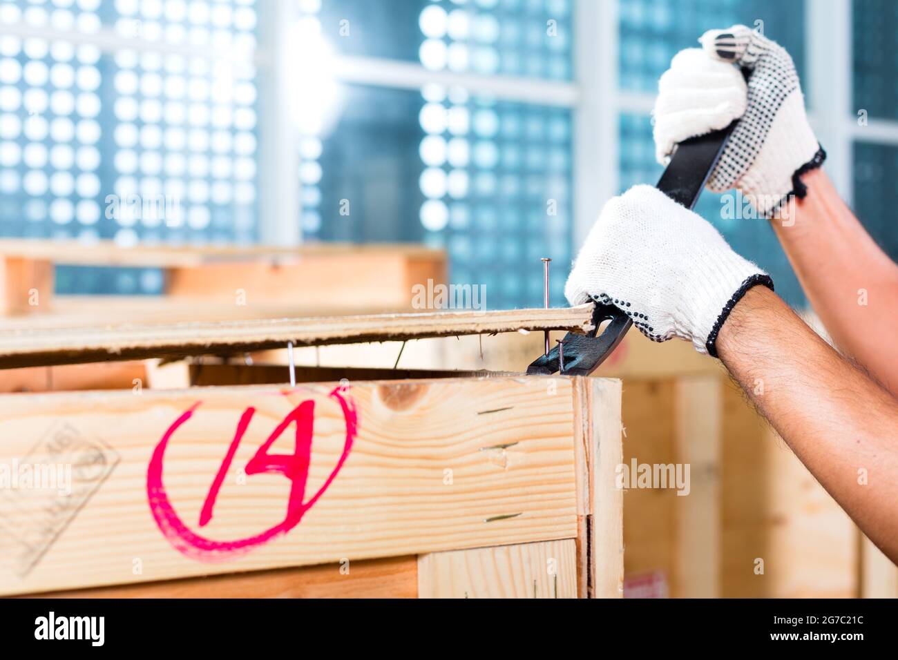 construction worker on a building site close a wood box or cargo ...