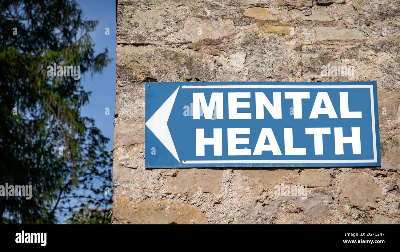 Mental Health concept. Blue directional sign on a dolomite masonry wall ...
