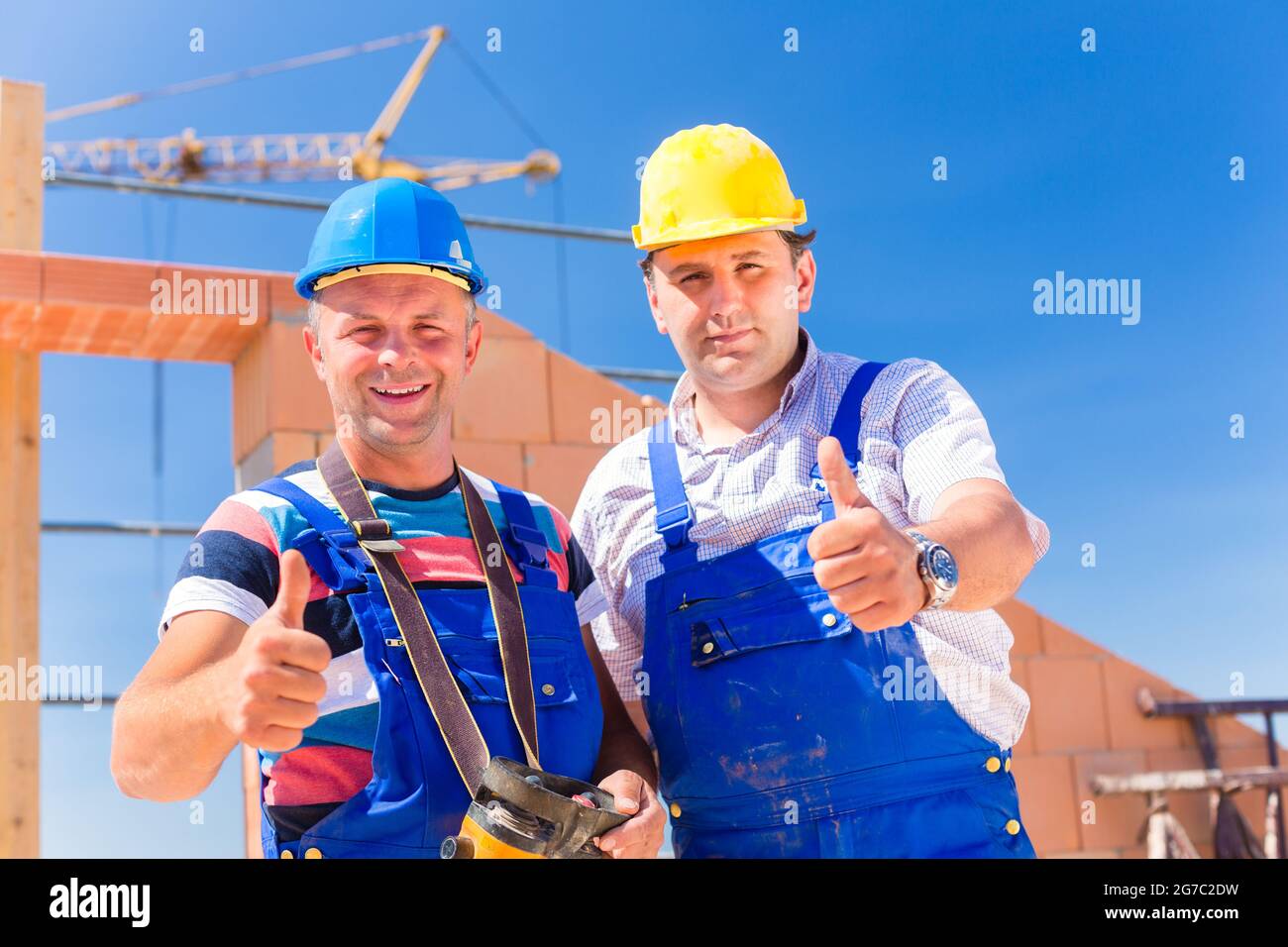 Construction site worker building a home or house doing bricklaying ...