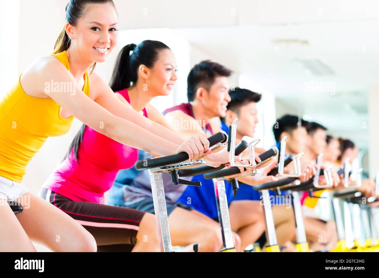 Chinese Asian sport group of men and women in fitness club or gym ...