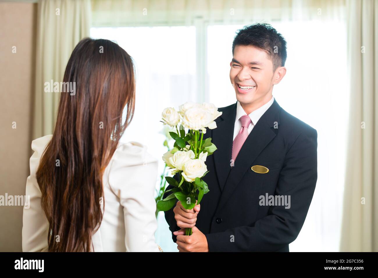 Asian Chinese Hotel Manager or director or supervisor welcome arriving ...