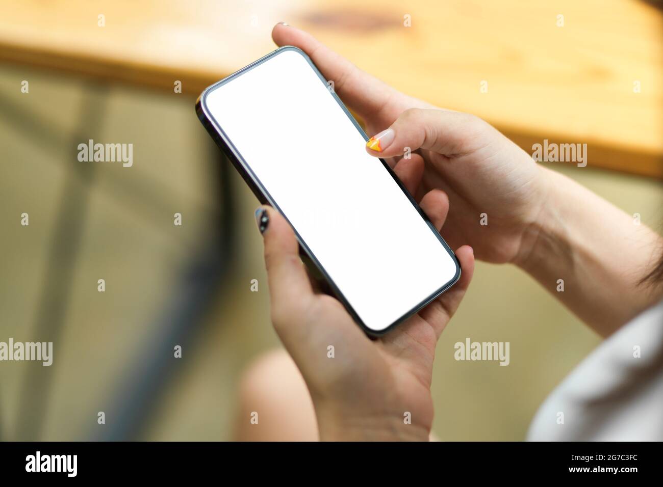 A beautiful young Asian woman using her smartphone in the room. chat ...