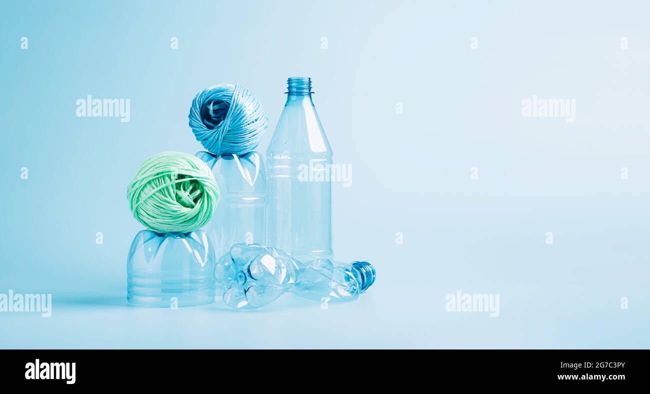 Plastic recycling and reuse concept. Empty plastic bottle and polyester ...